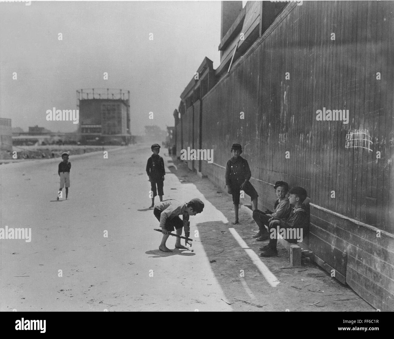 NEW YORK: TENEMENT LIFE./nBoys playing a game near tenements in New ...