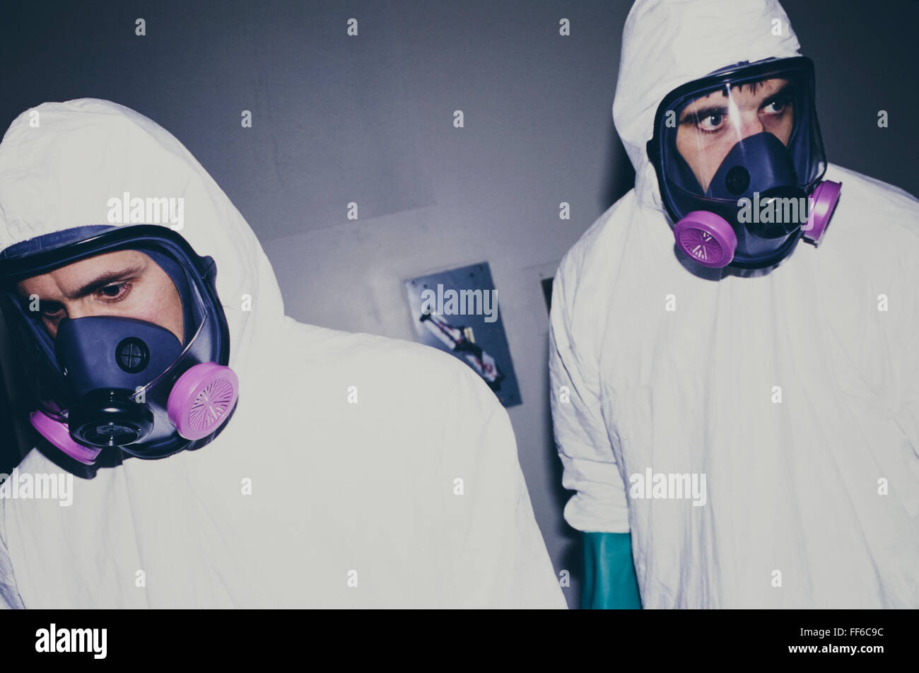 Two men wearing protective clean suits and breathing masks Stock Photo ...