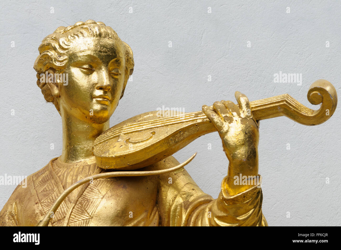 Gilded sandstone statue portrait of a woman playing a violin-link ...