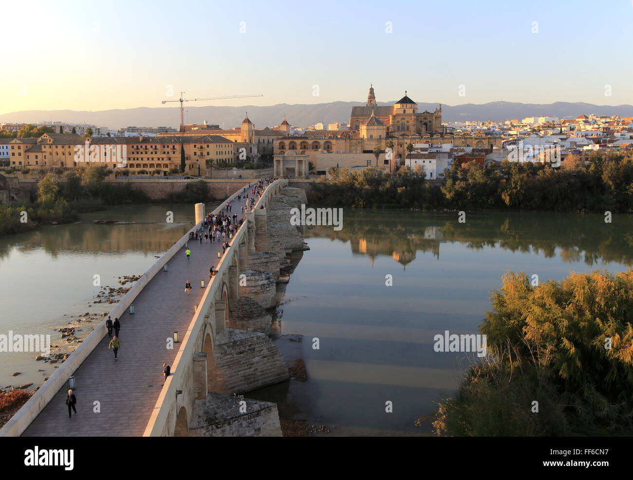 Roman bridge spanning river Rio Guadalquivir with Mezquita cathedral ...