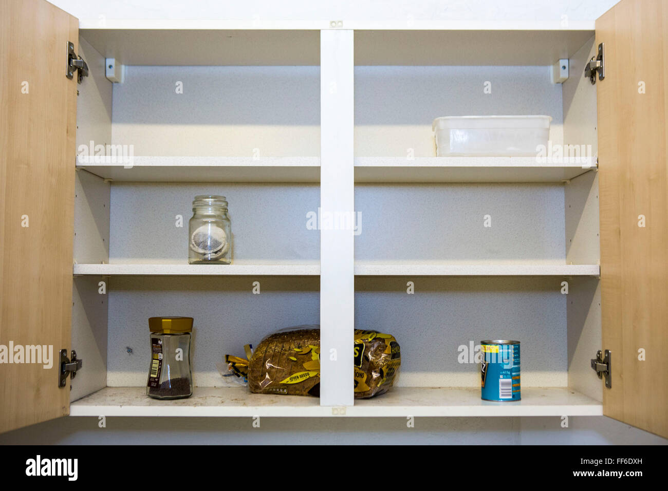An almost empty food cupboard in a family home in Hackney, London ...