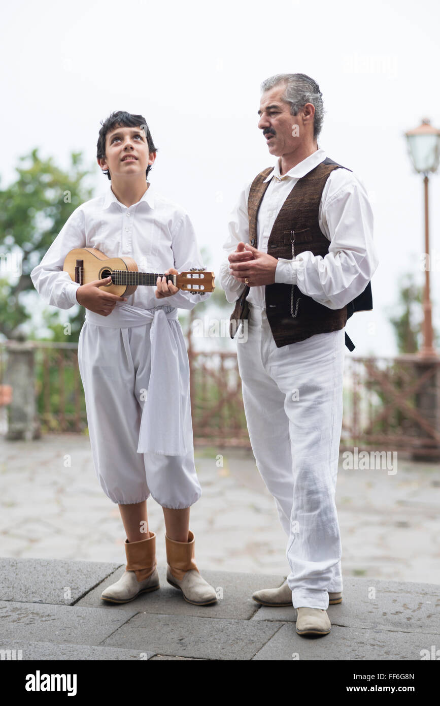 Man and child of a local music and folk dance group from Madeira in ...