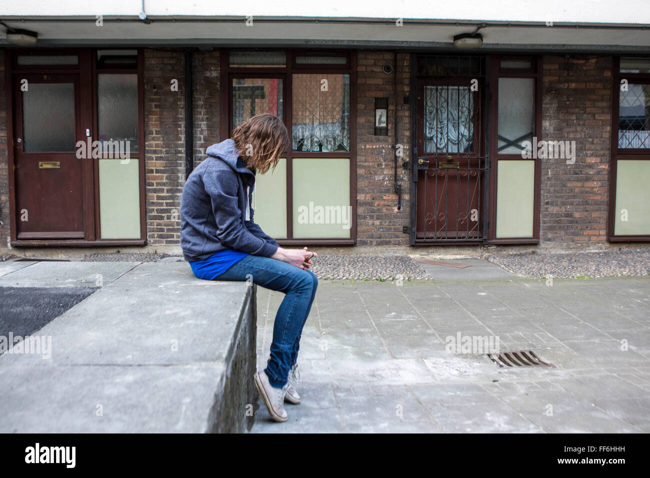 A vulnerable teenage youth hanging about on a Hackney estate, London ...