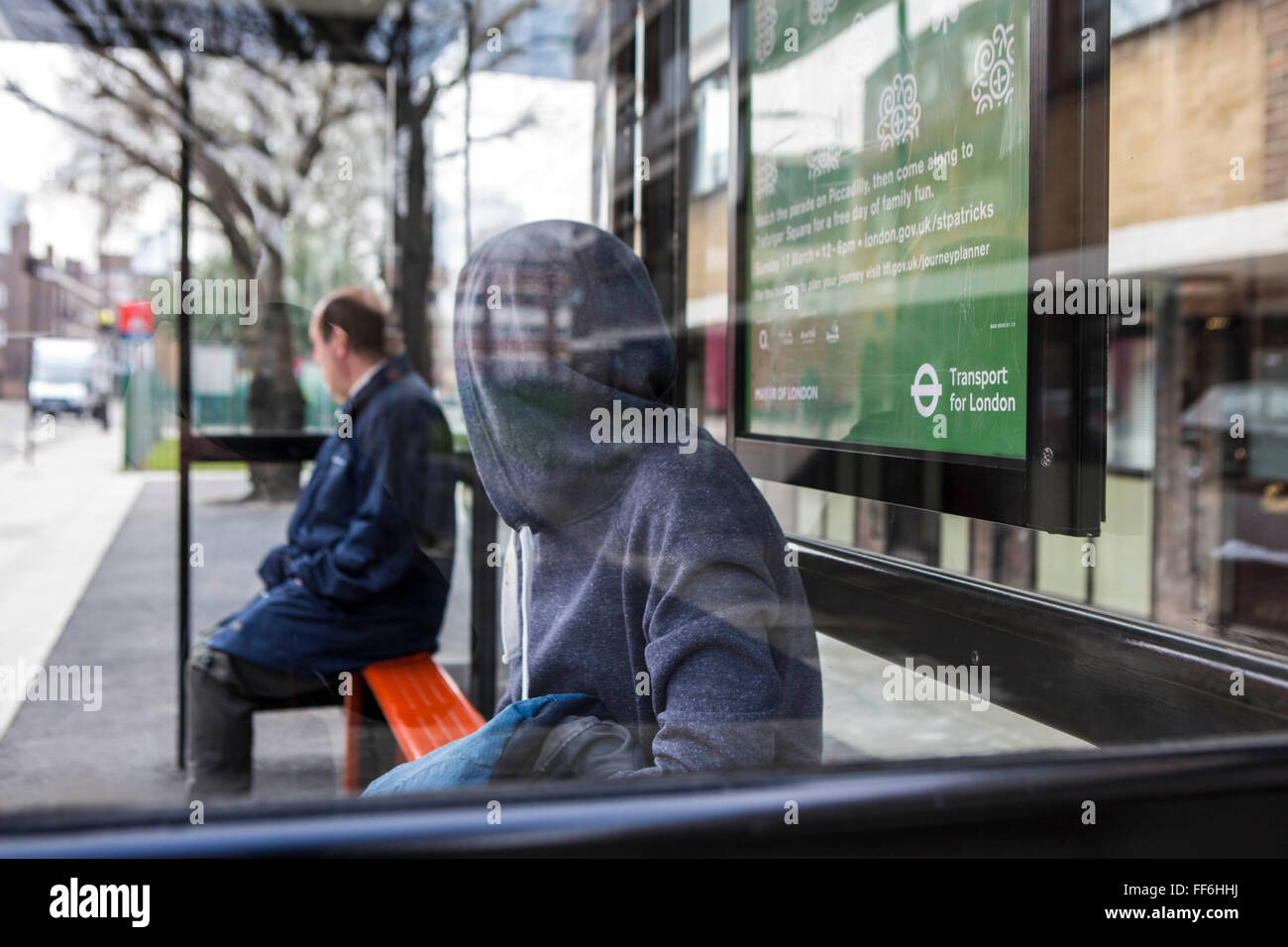 A vulnerable teenage youth ata bus stop on a Hackney estate, London. UK ...