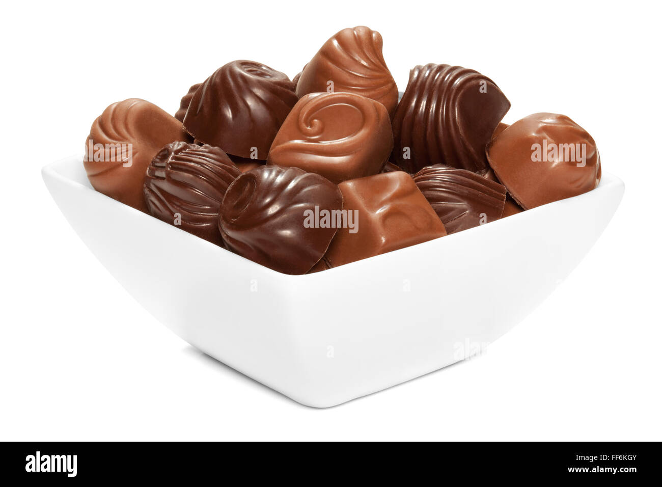 Chocolate sweets in white bowl, isolated on the white background ...