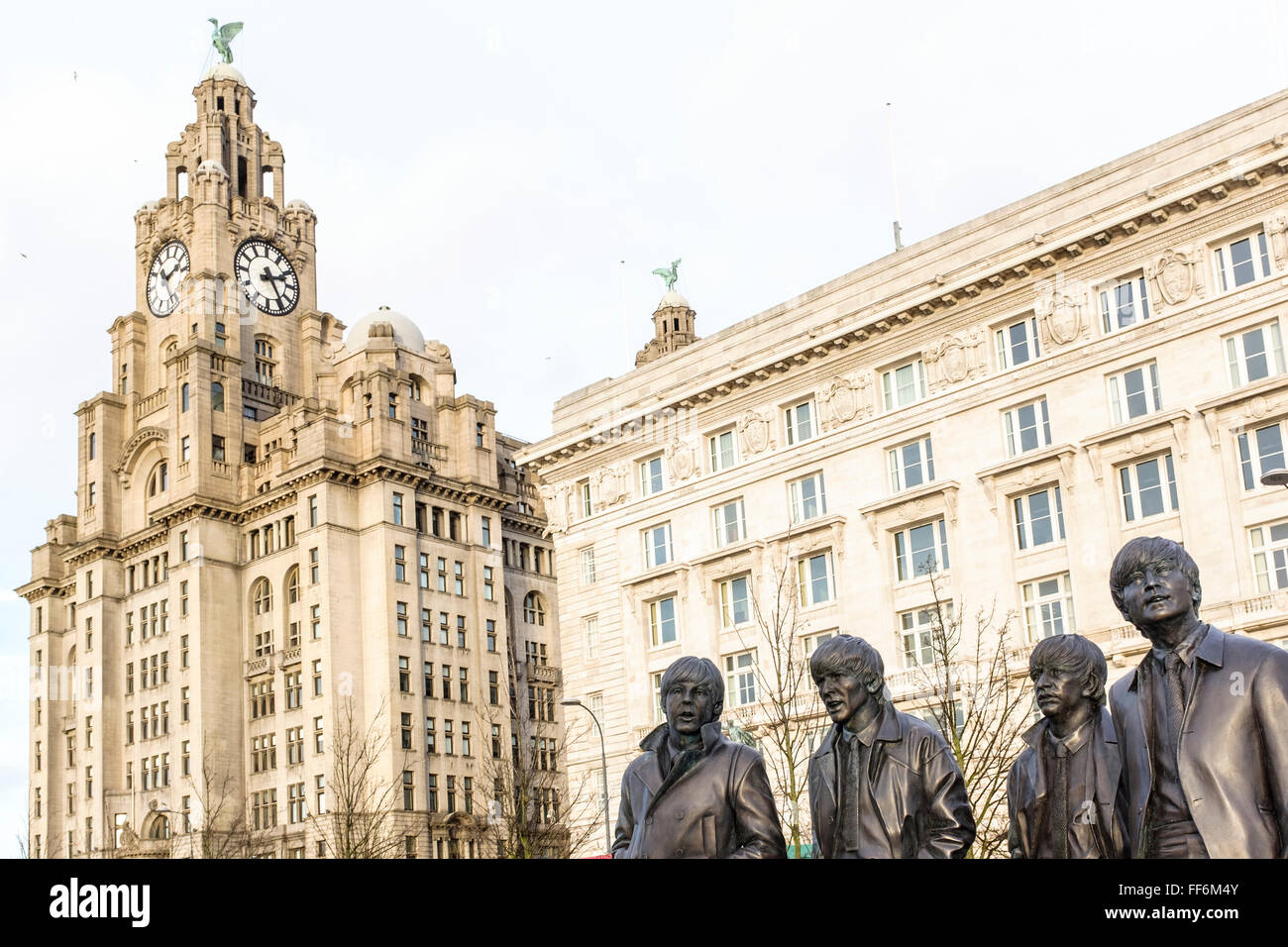 The Beatles statues at the pier head in Liverpool, UK with the Royal ...