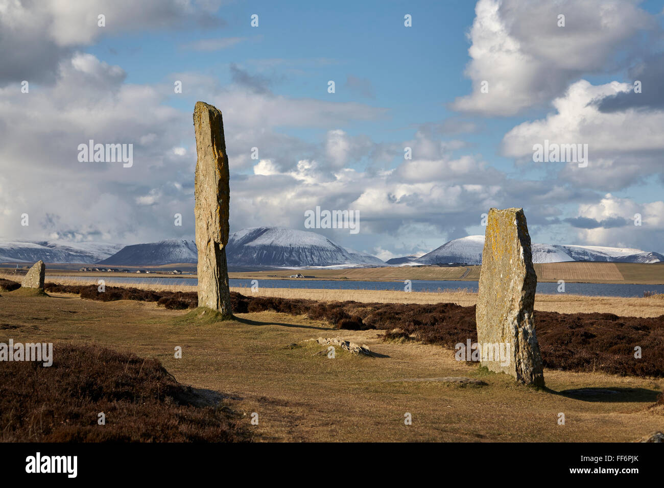 Ring of Brodgar Orkney with a view of the mountains of Hoy in snow ...