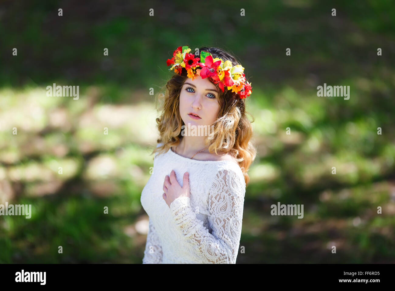 Portrait of a beautiful girl with flowers in her hair at spring time ...