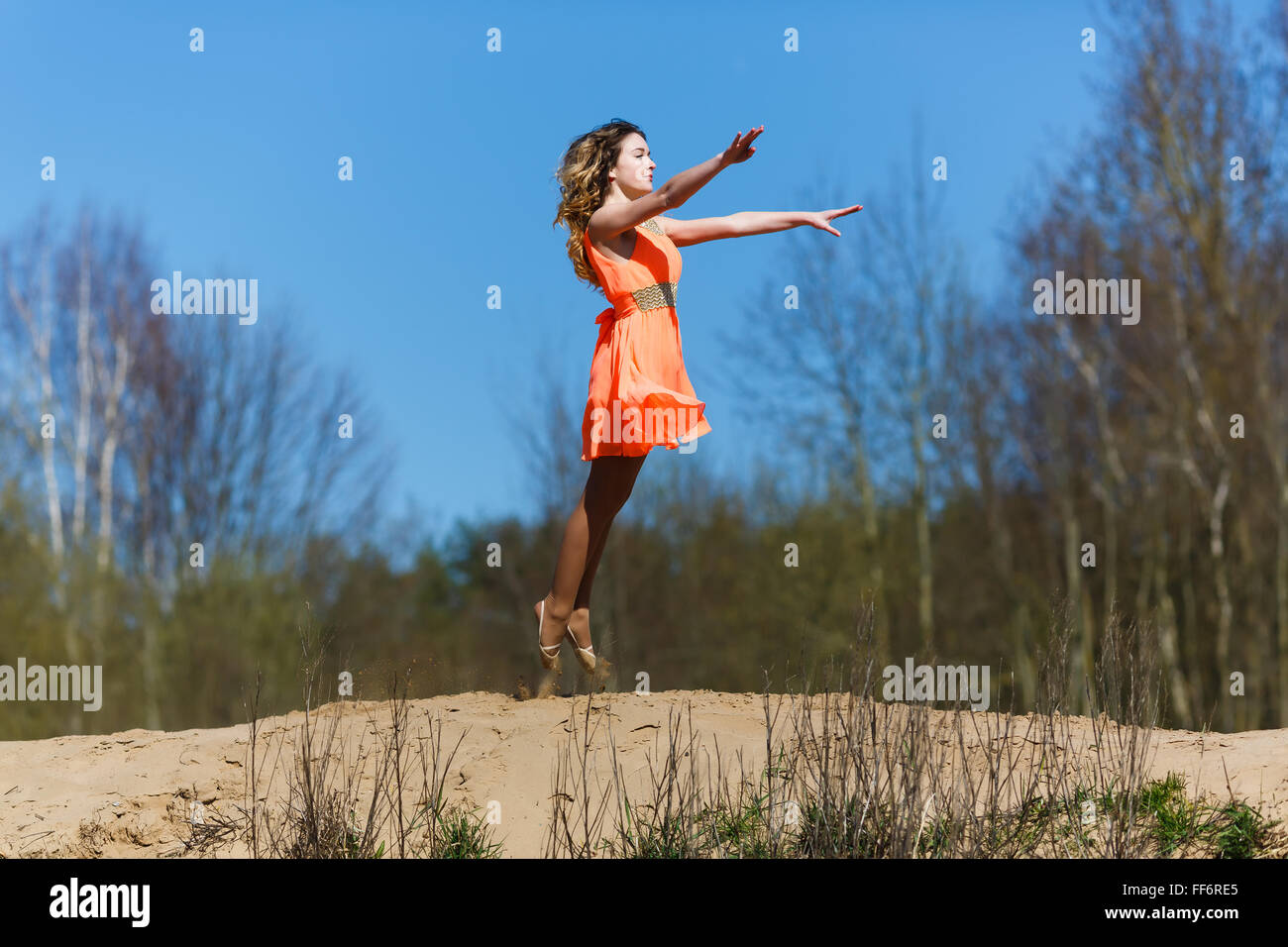 Young gymnast doing exercises in a forest at spring time Stock Photo ...