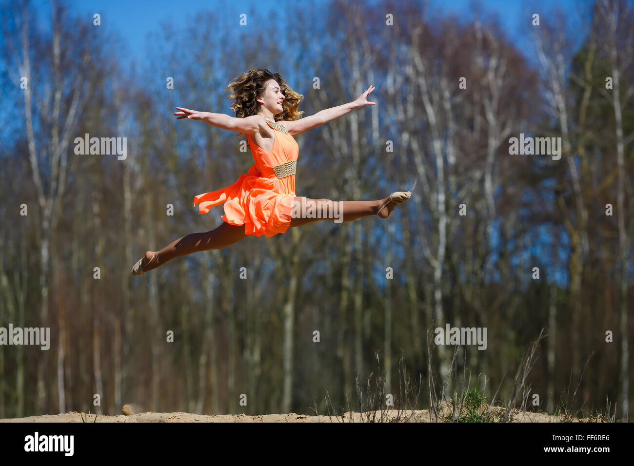 Young gymnast doing exercises in a forest at spring time Stock Photo ...