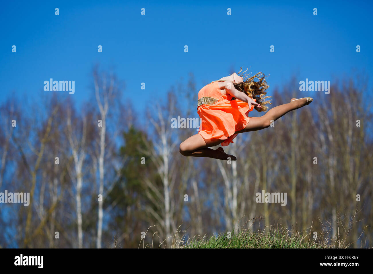 Young gymnast doing exercises in a forest at spring time Stock Photo ...