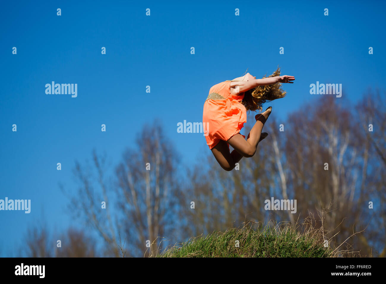 Young gymnast doing exercises in a forest at spring time Stock Photo ...