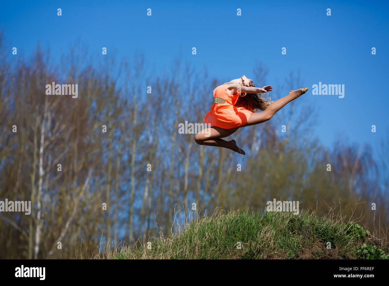 Young gymnast doing exercises in a forest at spring time Stock Photo ...