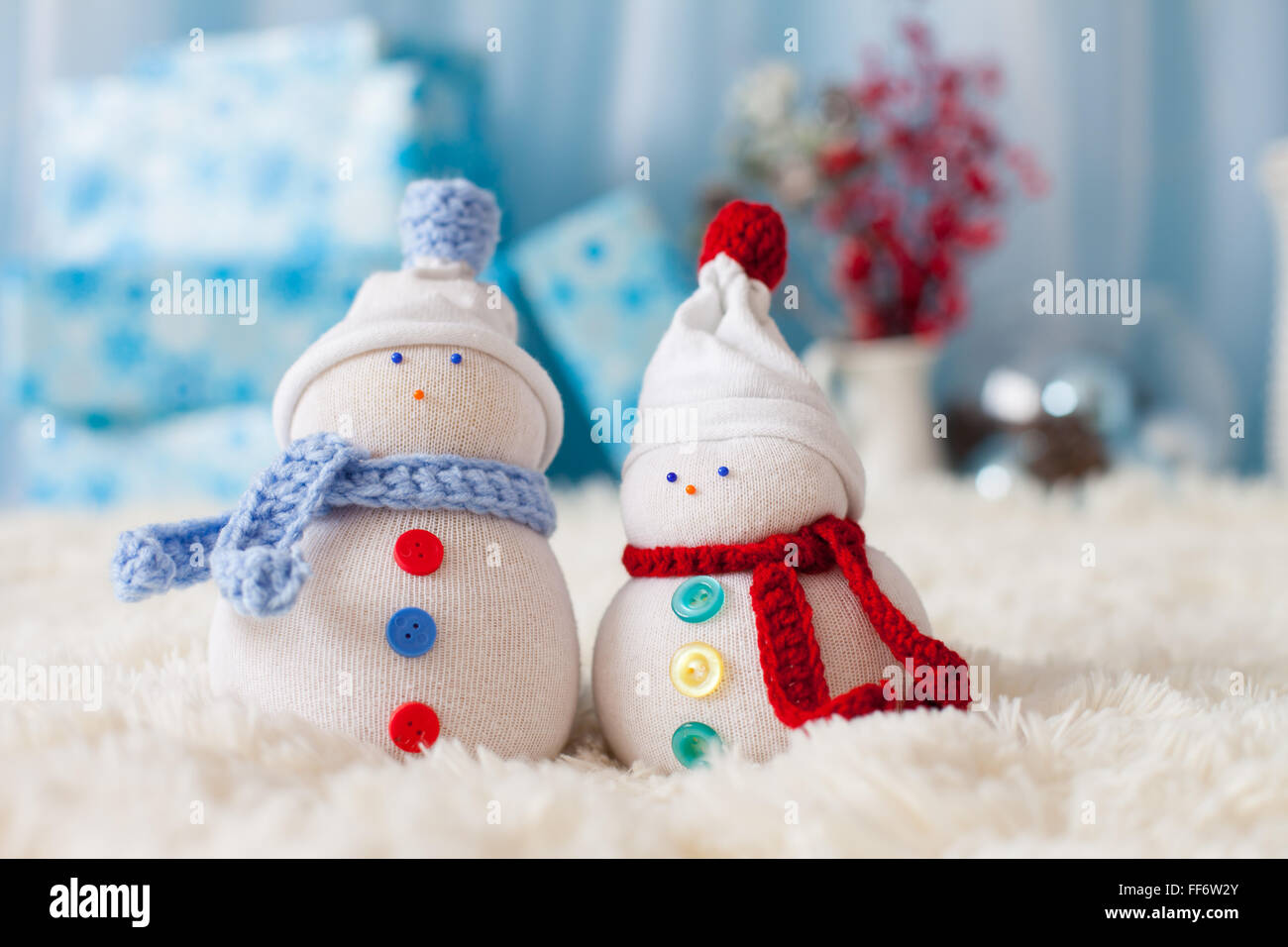 Two handmade snowmen with Christmas light background on white fur Stock ...