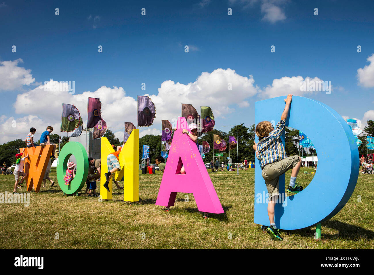 Kids climbing on the WOMAD sign. WOMAD 2014, festival of world music ...