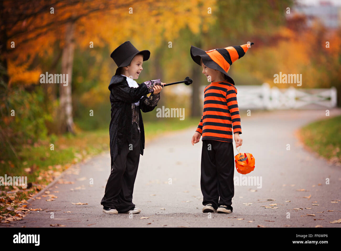 Two boys in the park with Halloween costumes, having fun Stock Photo ...