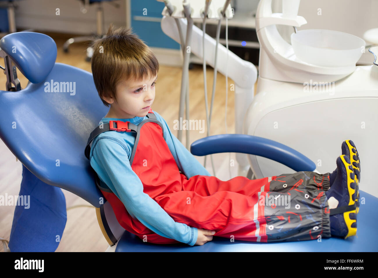 Scared little child, boy, sitting on dentist chair, waiting for his ...