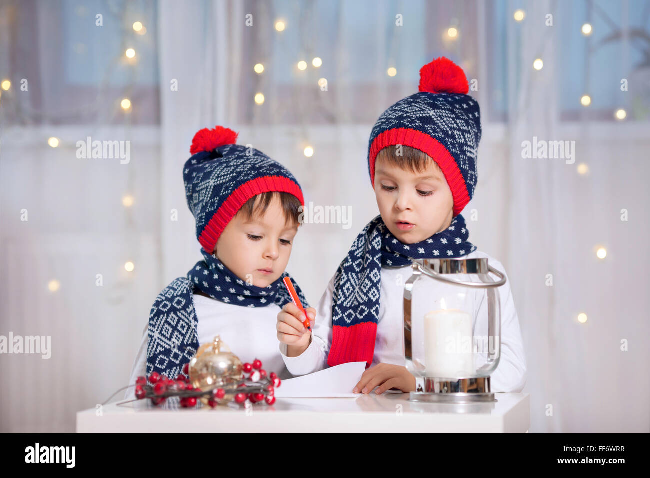 Two adorable little preschooler children, boy brothers, writing letter ...