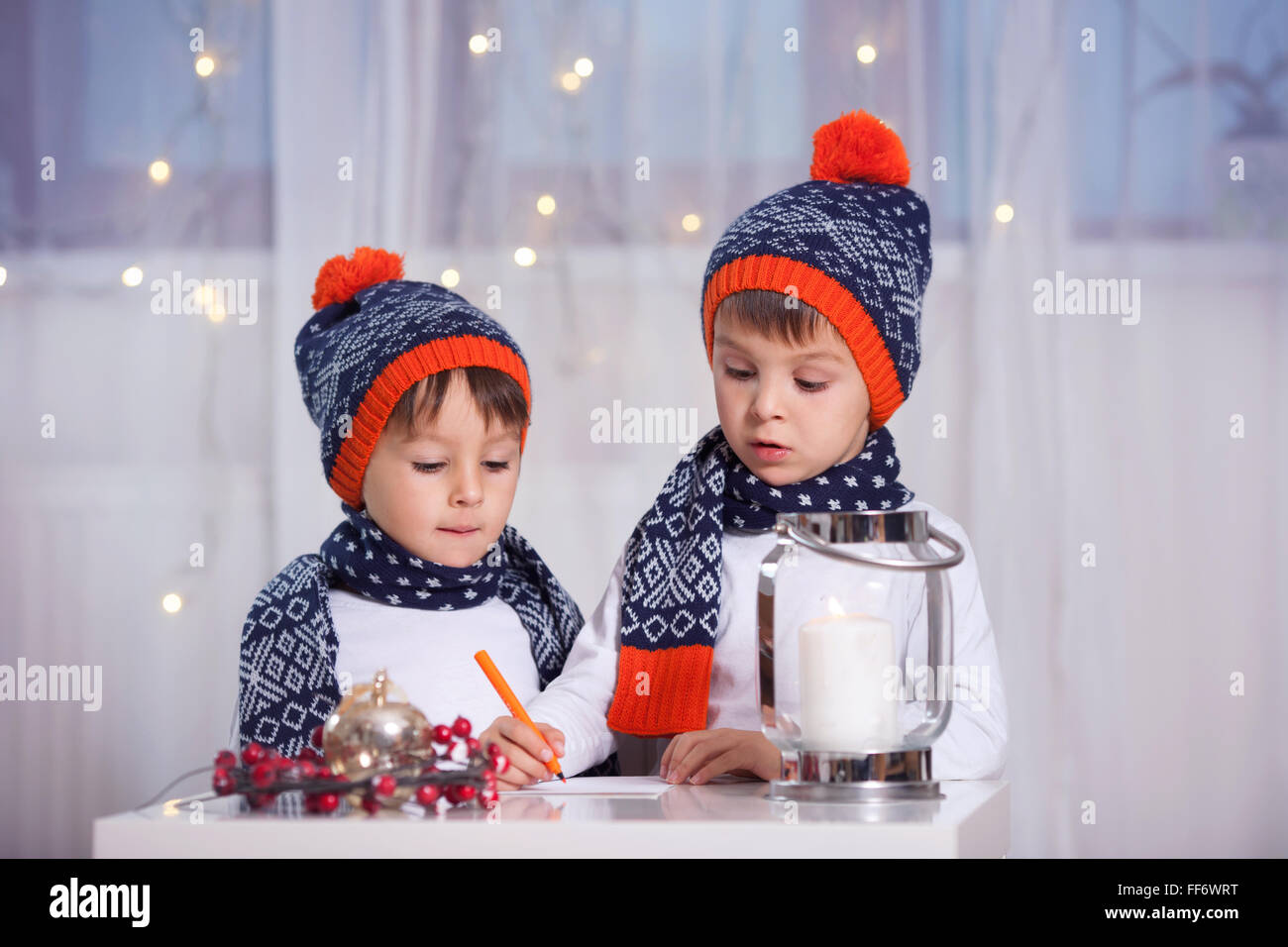 Two adorable little preschooler children, boy brothers, writing letter ...