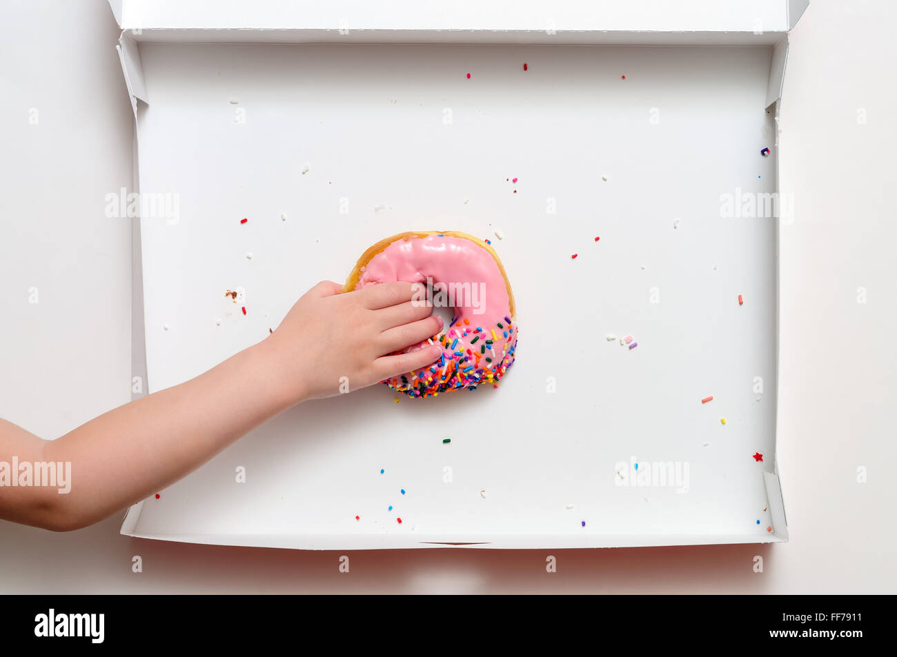 Child grabbing donut hi-res stock photography and images - Alamy