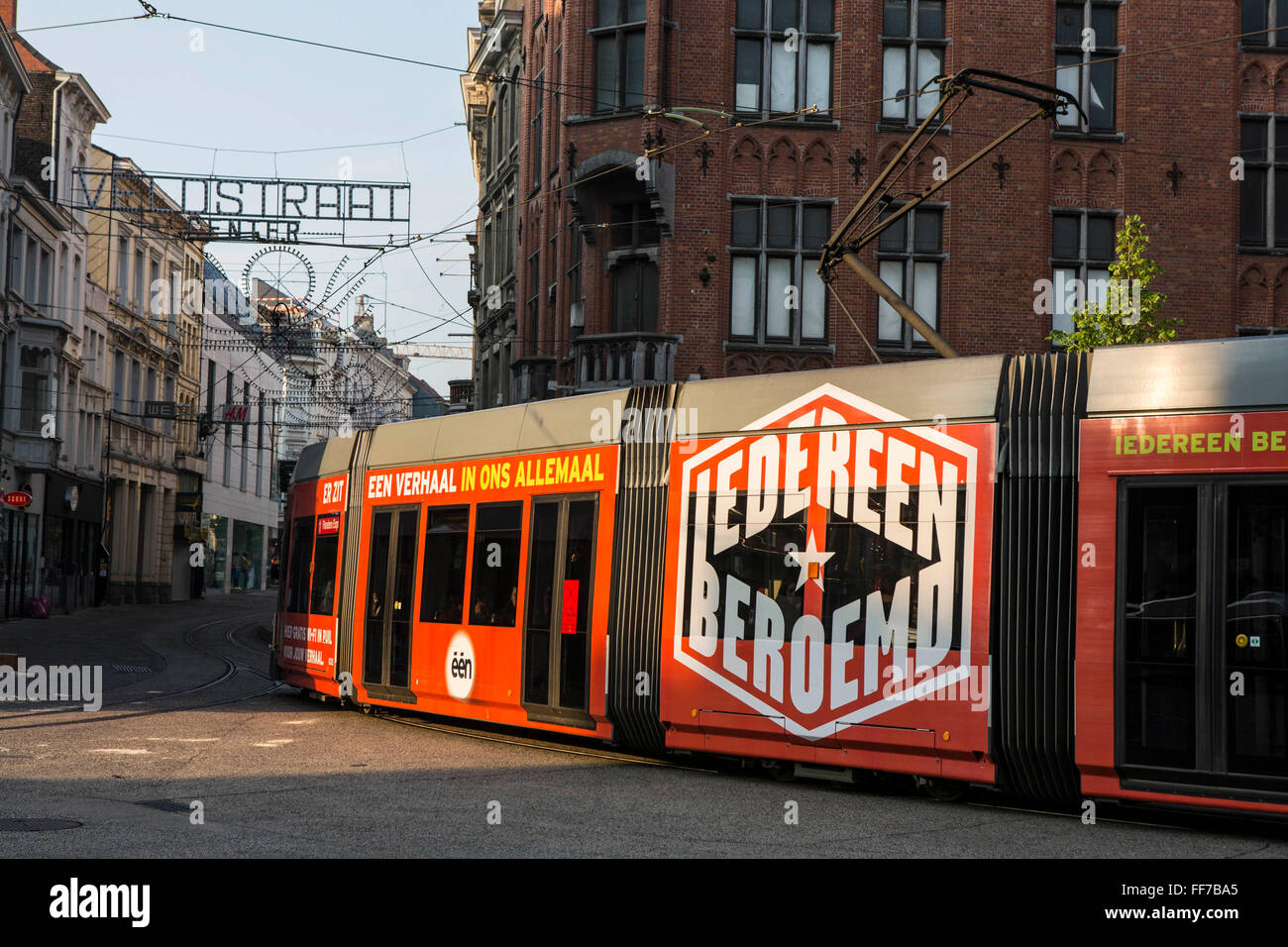 A modern De Lijn tram turns a corner on the tram network in central ...