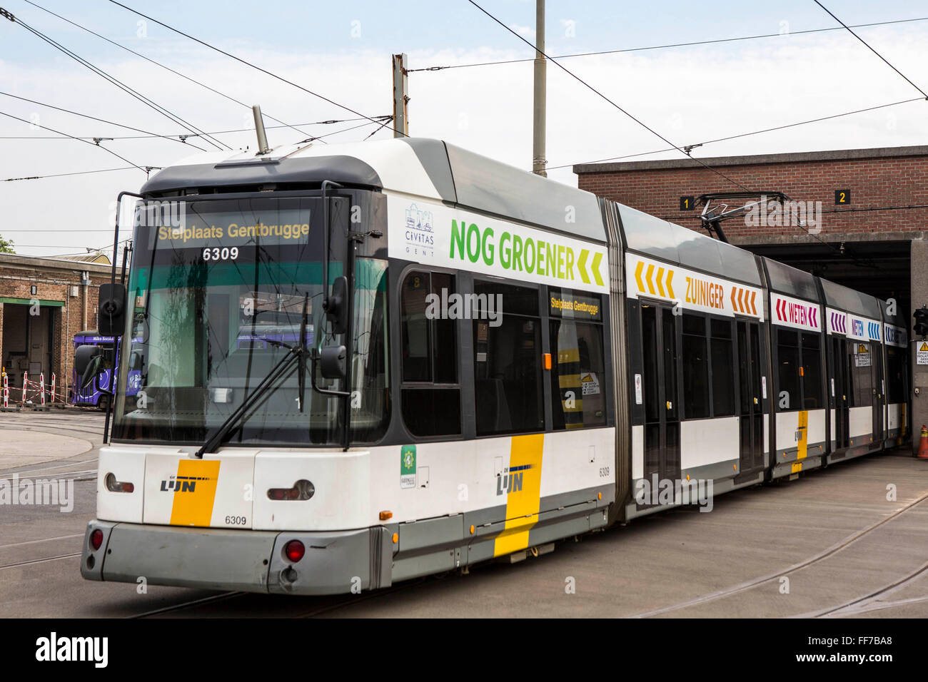 A modern De Lijn electric tram leaves the depot in Ghent, Belgium. The ...