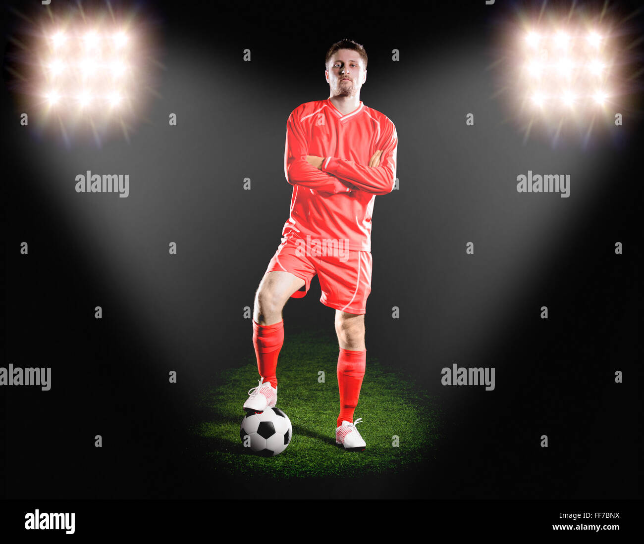 football player in red uniform. on grass field Stock Photo - Alamy