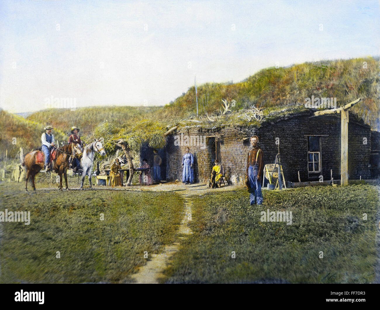 PIONEER'S SOD HOUSE, 1887. /nA pioneer family alongside their sod house ...