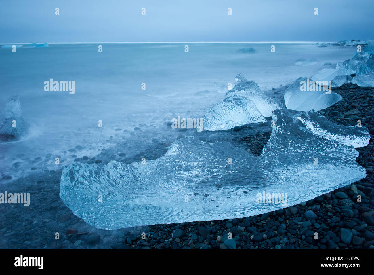 A blue Iceberg washed onto the crystal beach near Jokulsarlon Glacier ...