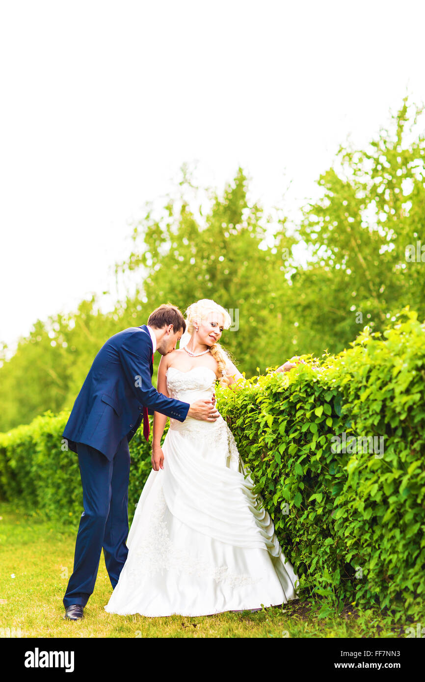 wedding pair hugging and kissing Stock Photo - Alamy