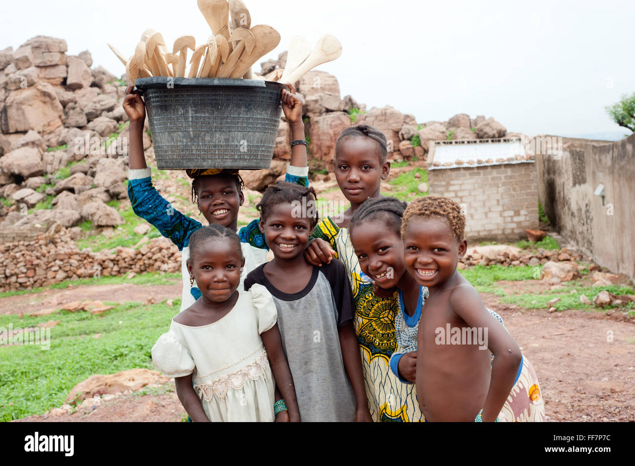 Mali, Africa - Young people carrying food, cereals in a village near ...