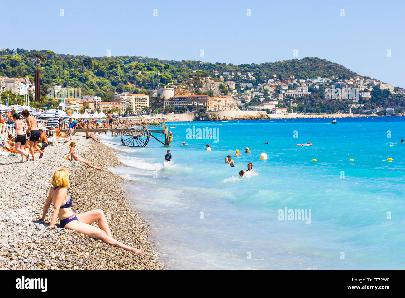 NICE, FRANCE - AUGUST 23: Tourists enjoy the good weather at the beach ...