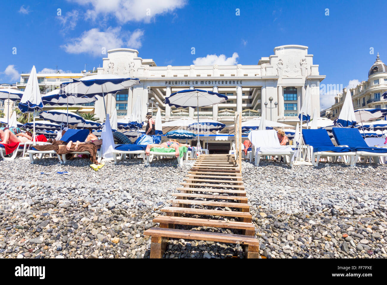 NICE, FRANCE - AUGUST 23: Tourists enjoy the good weather at the beach ...