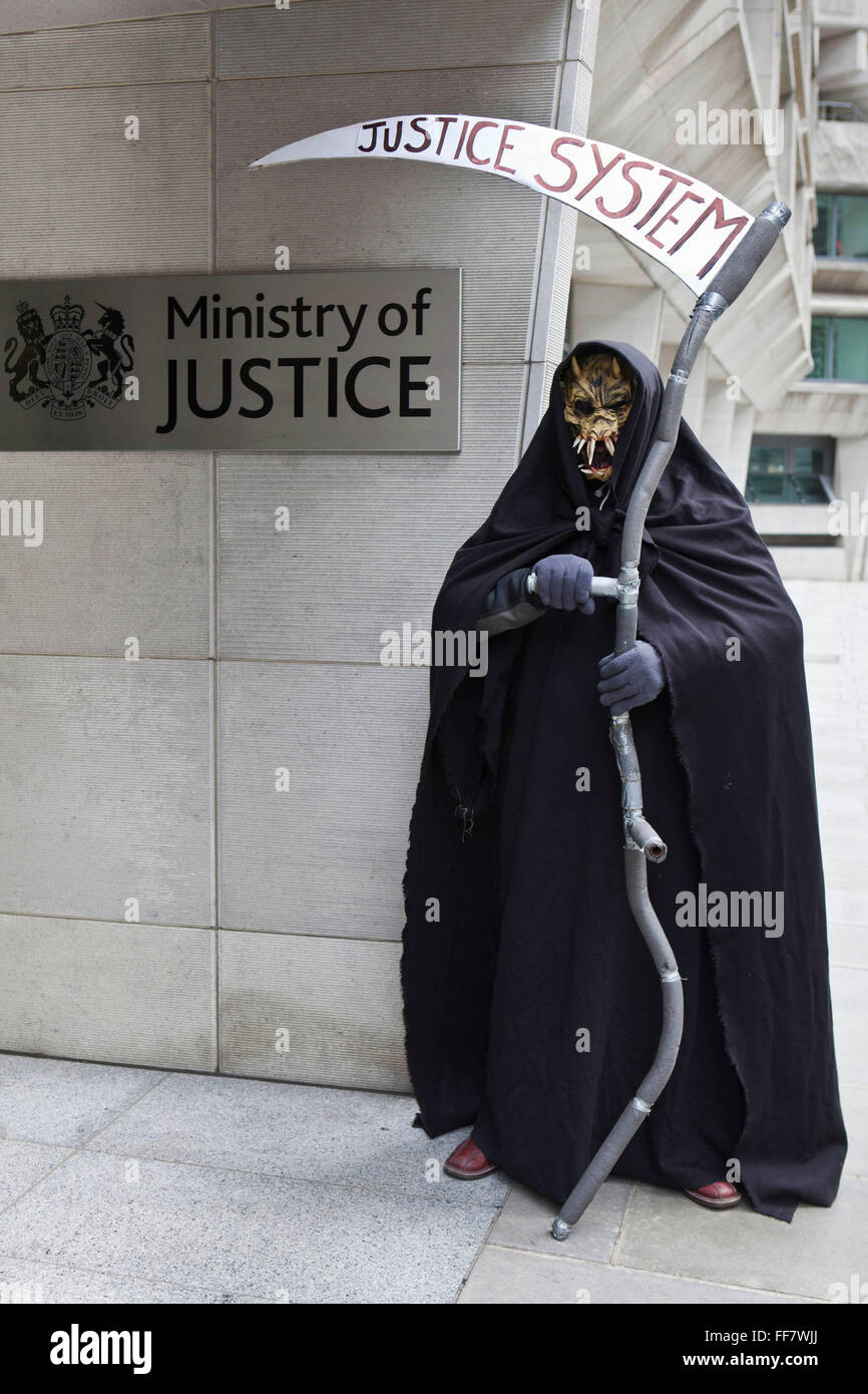 A court closure protester dressed as the Grim Reaper poses in front of ...