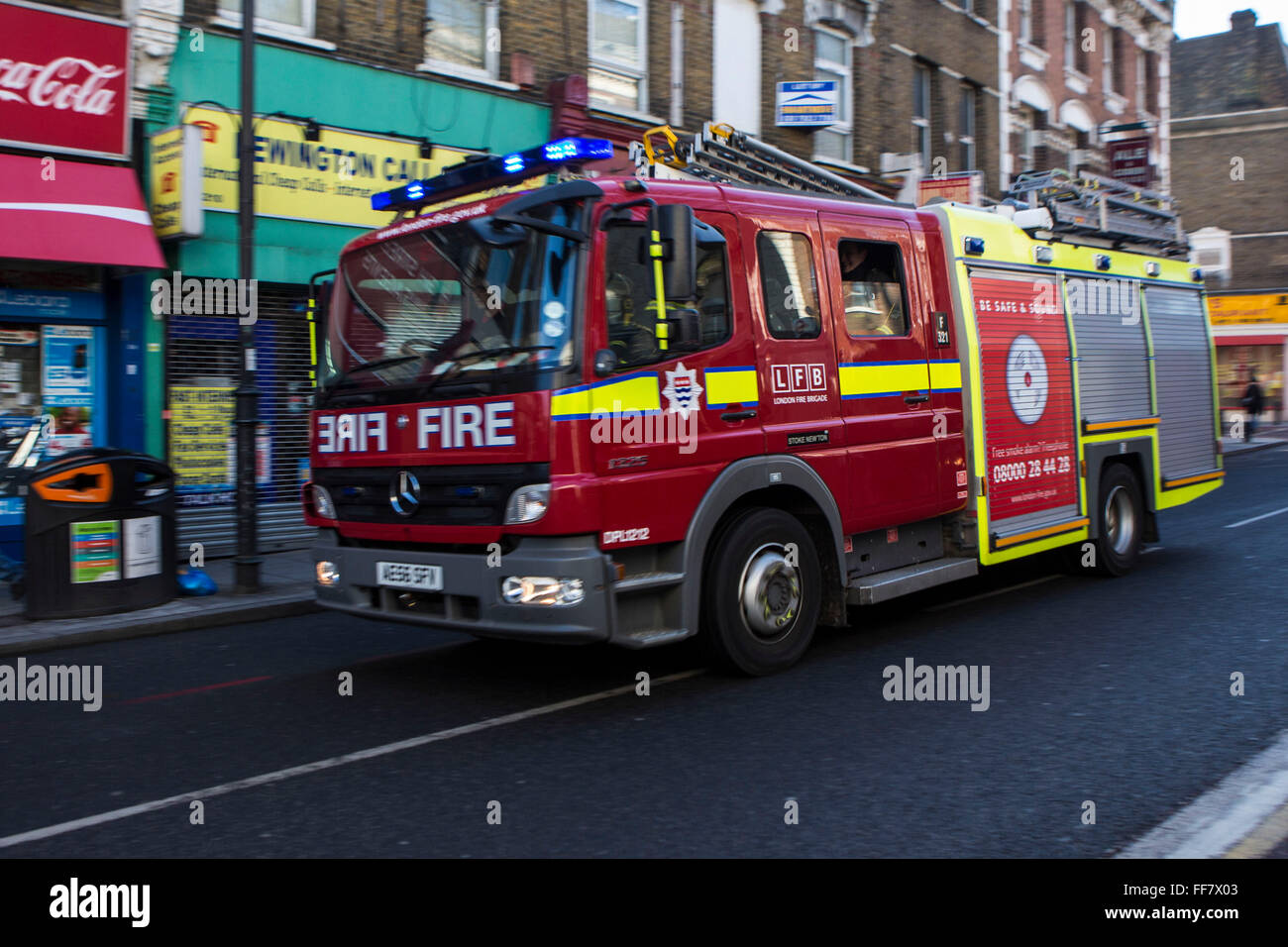 A London Fire Brigade fire engine drives to an emergency on Stoke ... A London Fire Brigade fire engine drives to an emergency on Stoke ...