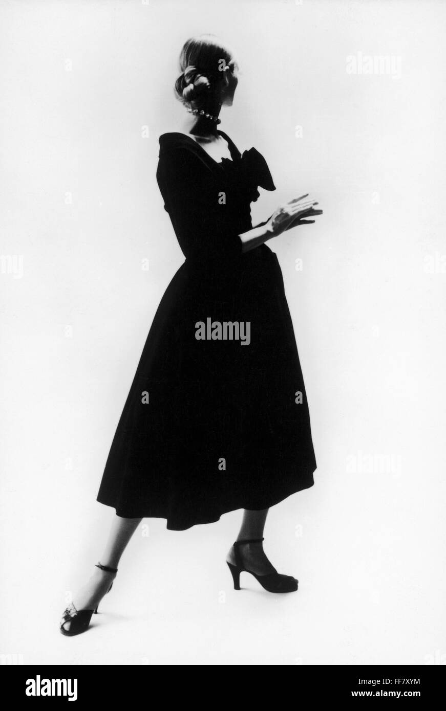 FASHION: DIOR, 1947. /nBlack wool 'New Look' dress by Christian Dior ...