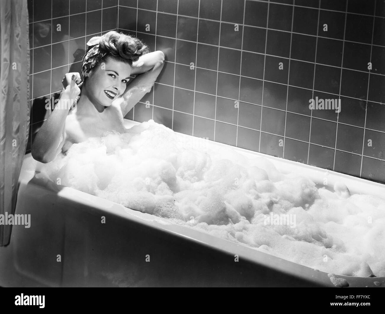 WOMAN IN BUBBLE BATH. /nAmerican magazine advertisement, 1940s Stock ...