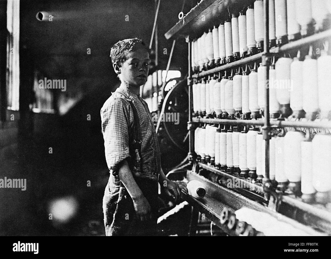 CHILD LABOR, 1909. /nTwelve year old John Dempsey working in the mule-spinning room of the ...