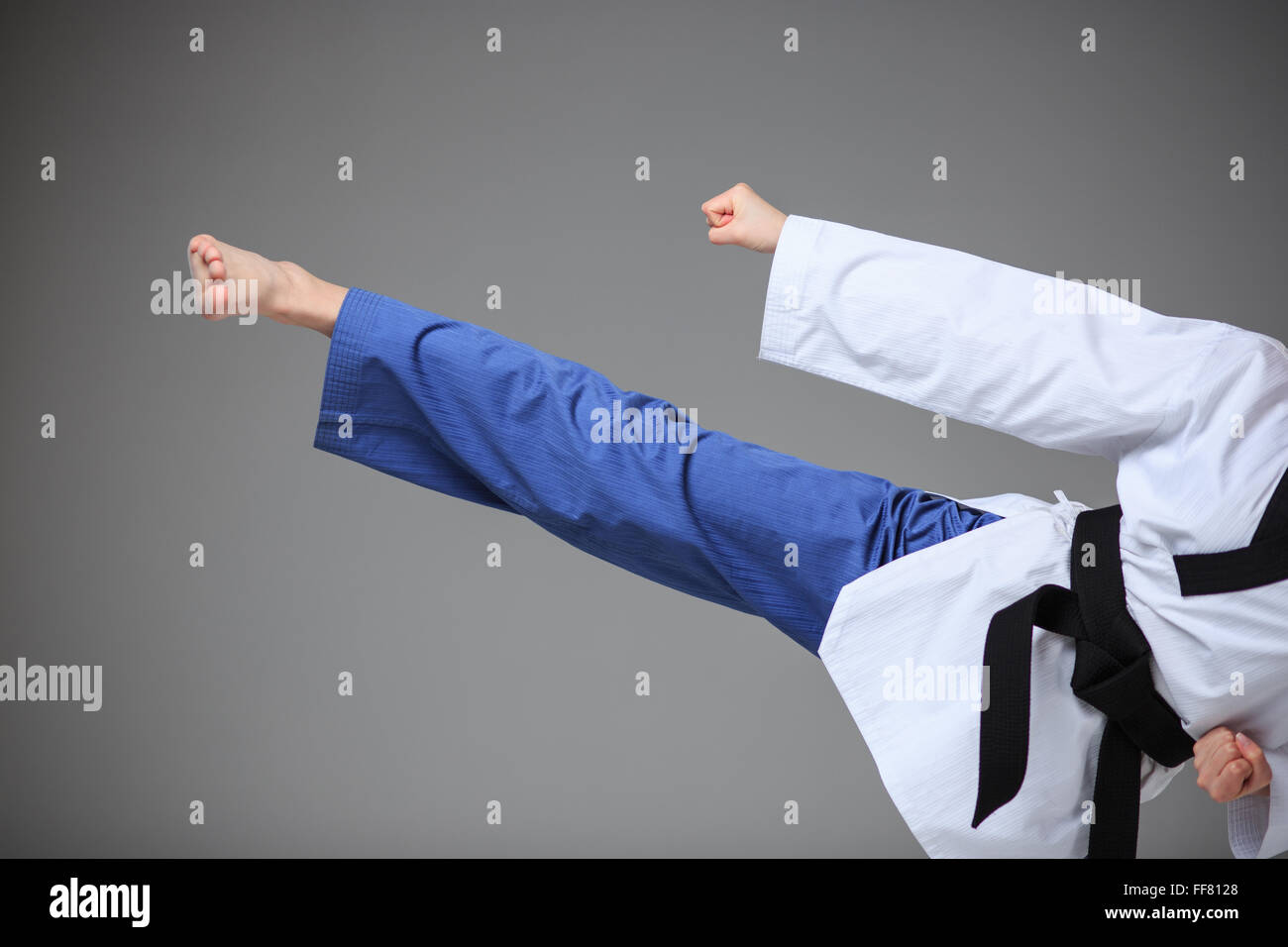 The hand and foot of karate girl in white kimono and black belt ...