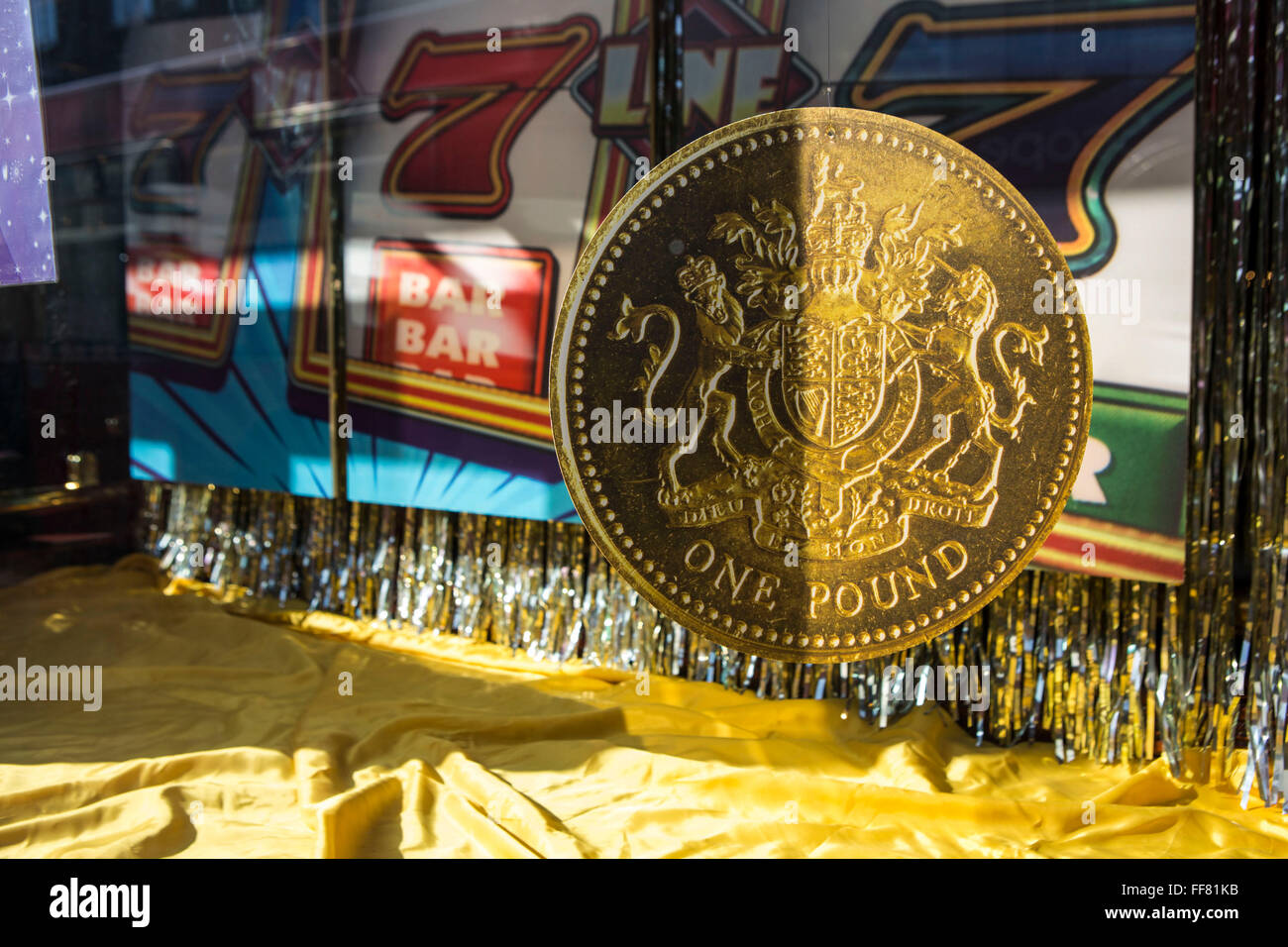 A large model of a British one pound coin in the window display of a ...