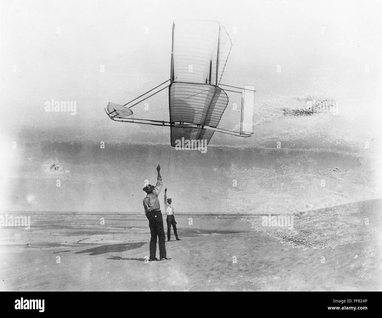 WRIGHT BROTHERS GLIDER. /nDan Tate (foreground) and Wilbur Wright ...