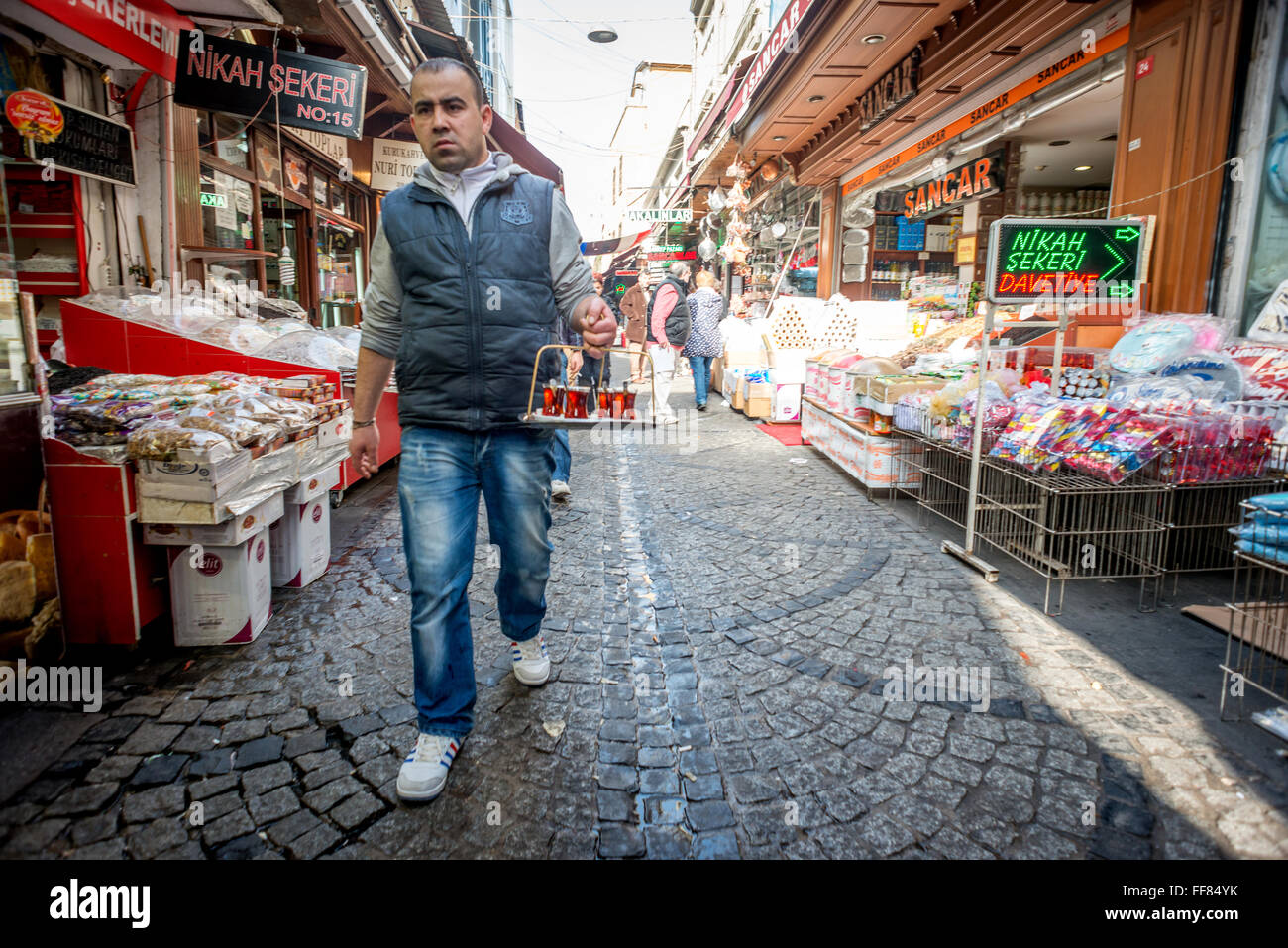 A man delivering tea to market traders in the Grand Bazaar of Istanbul ...