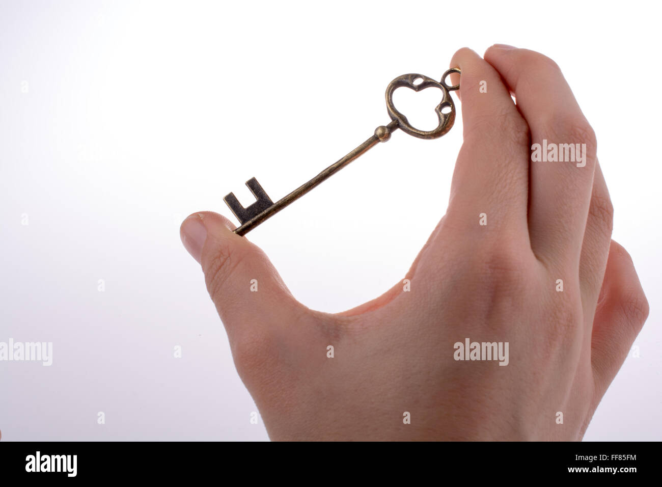 Hand holding a retro styled key Stock Photo - Alamy