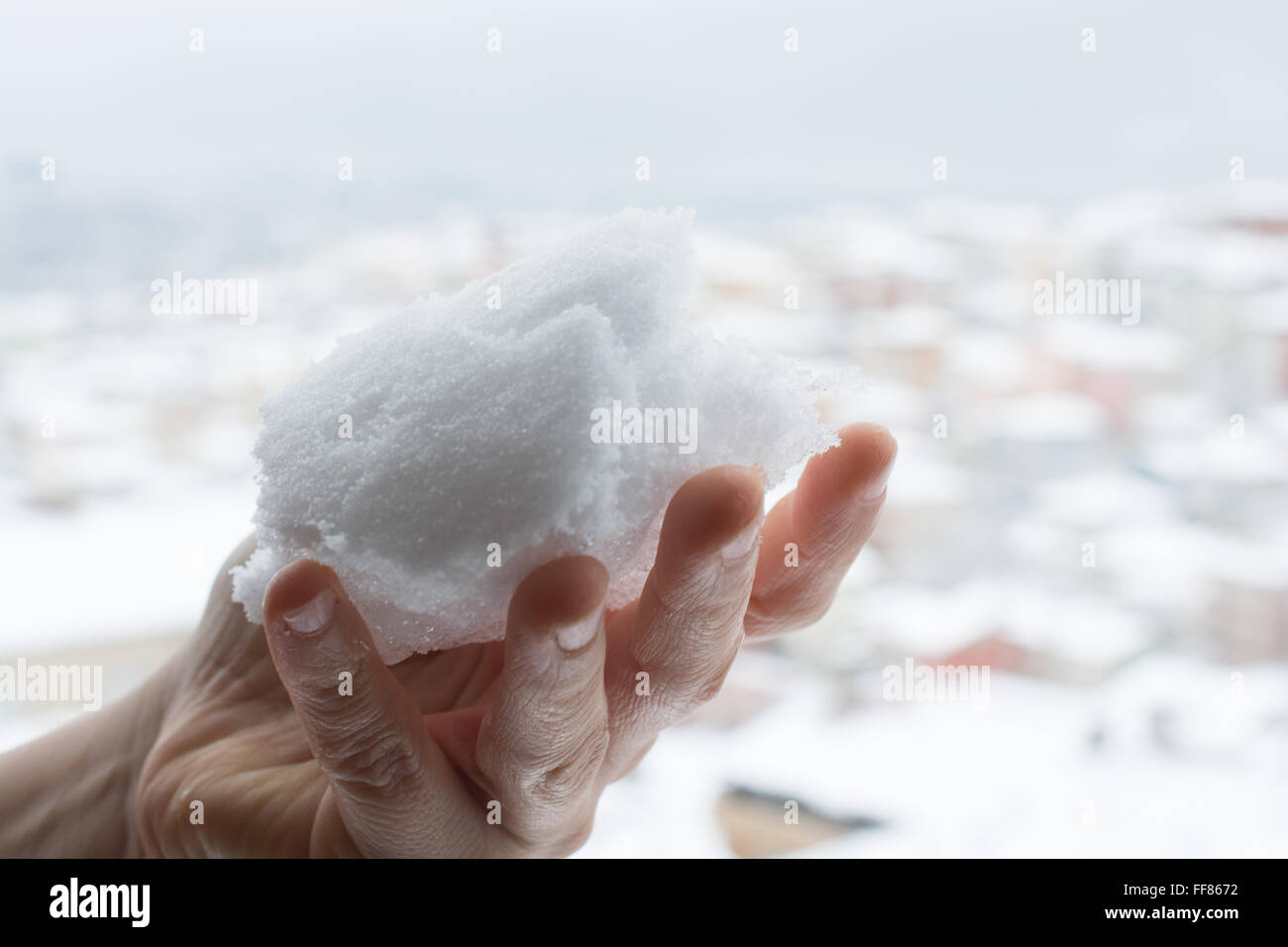 snow in hand hand with winter related background Stock Photo - Alamy