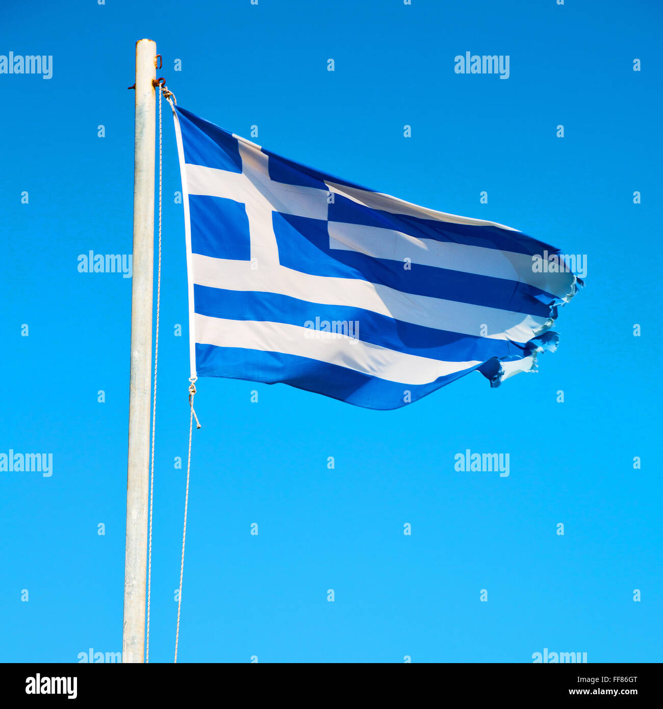 waving greece flag in the blue sky and flagpole Stock Photo - Alamy