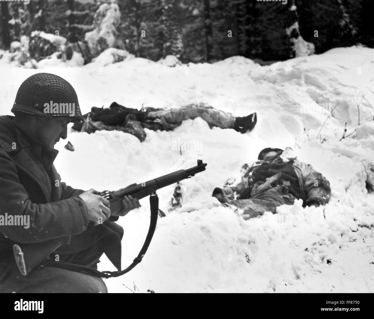 WORLD WAR II: U.S. TROOPS. /nAn American infantryman loads his rifle ...