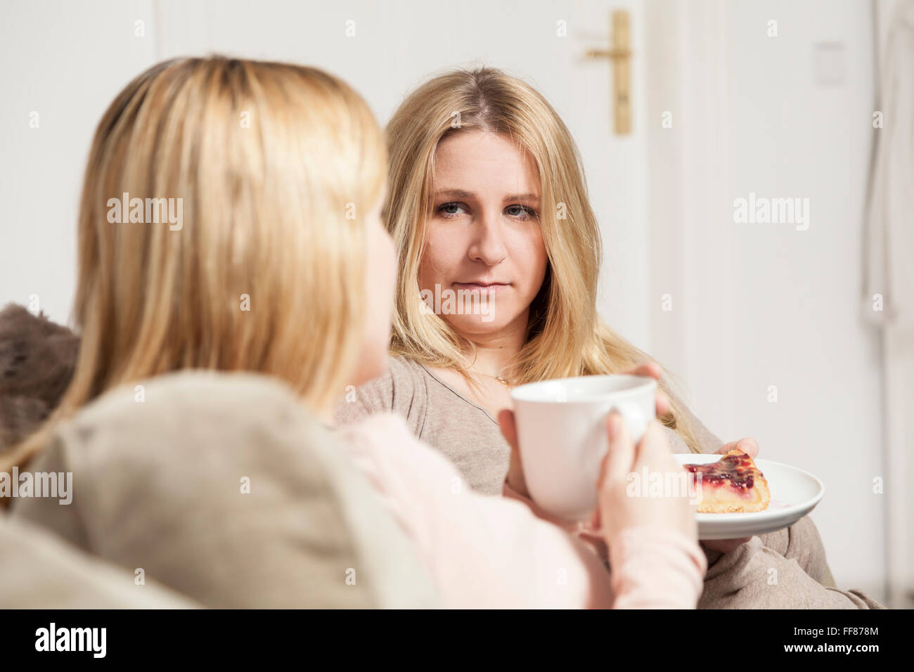girlfriends in coffee gossip, one is serious listening Stock Photo - Alamy