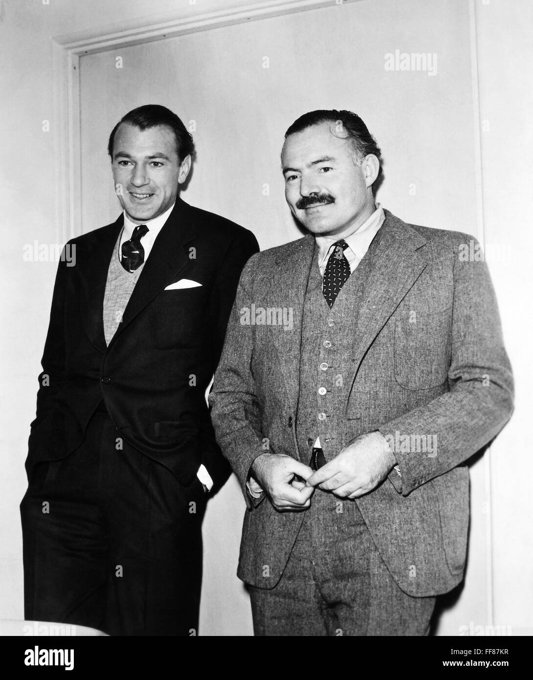 ERNEST HEMINGWAY /n(1899-1961). American writer. With actor Gary Cooper ...
