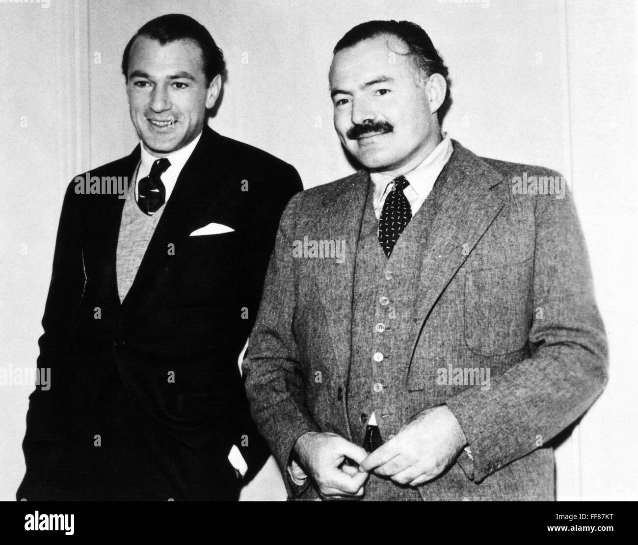ERNEST HEMINGWAY /n(1899-1961). American writer. With actor Gary Cooper ...