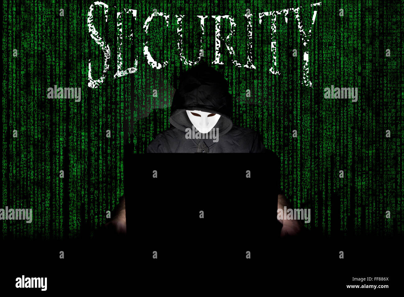 A masked man at a laptop symbolising the dangers of the Internet Stock ...